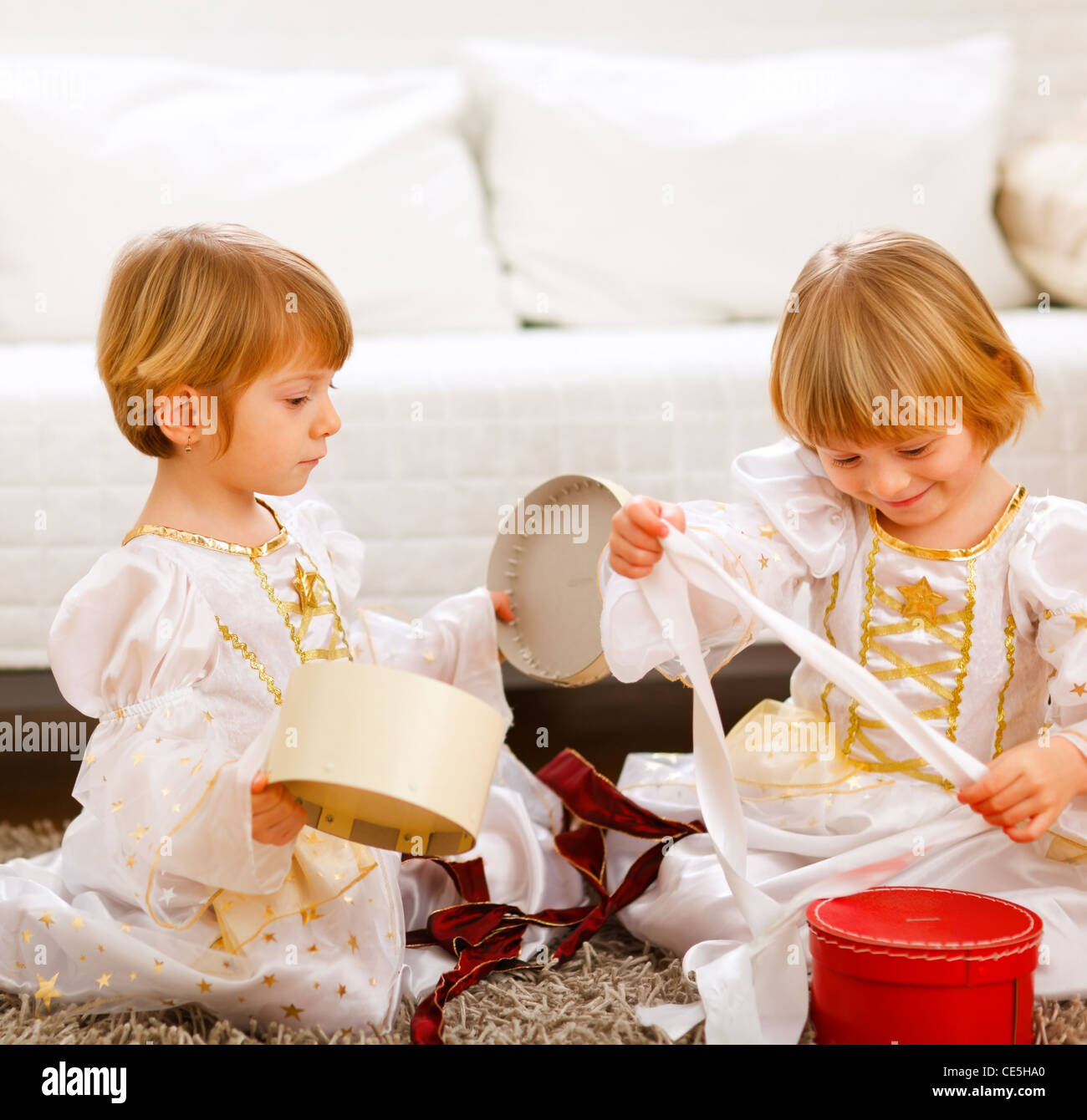 Two cute twins girls opening presents near Christmas tree Stock Photo ...