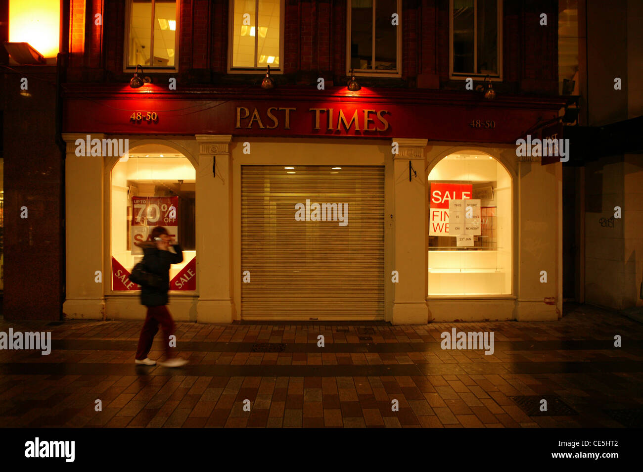 Person walking down lit street hi-res stock photography and images - Alamy