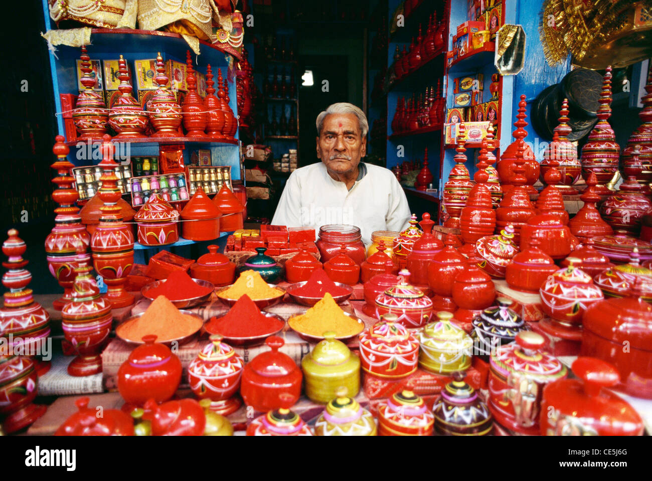 Man selling brightly painted wooden containers ; Varanasi ; Uttar ...