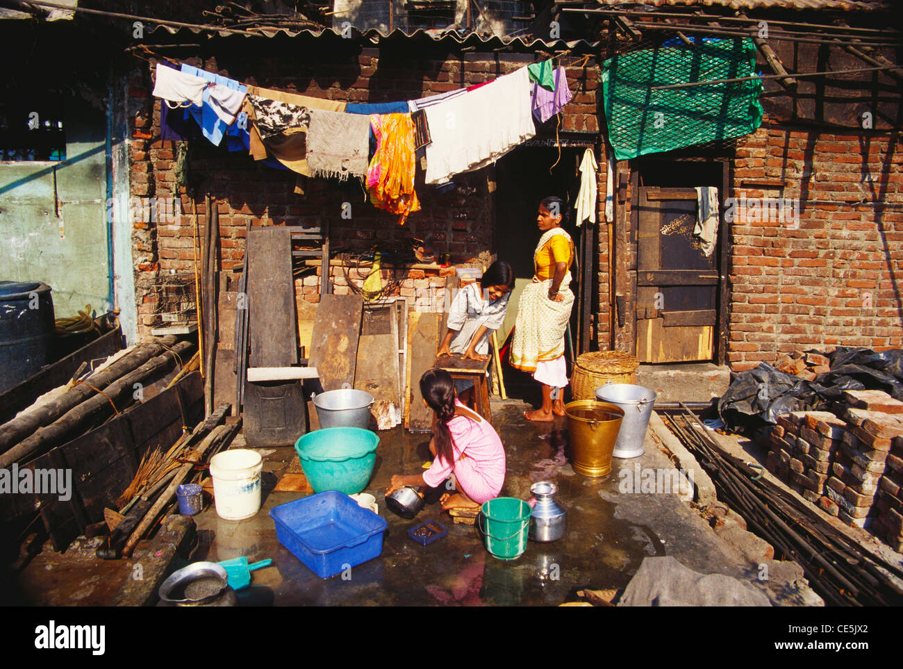 Slum house open washing utensils clothes drying bombay mumbai ...