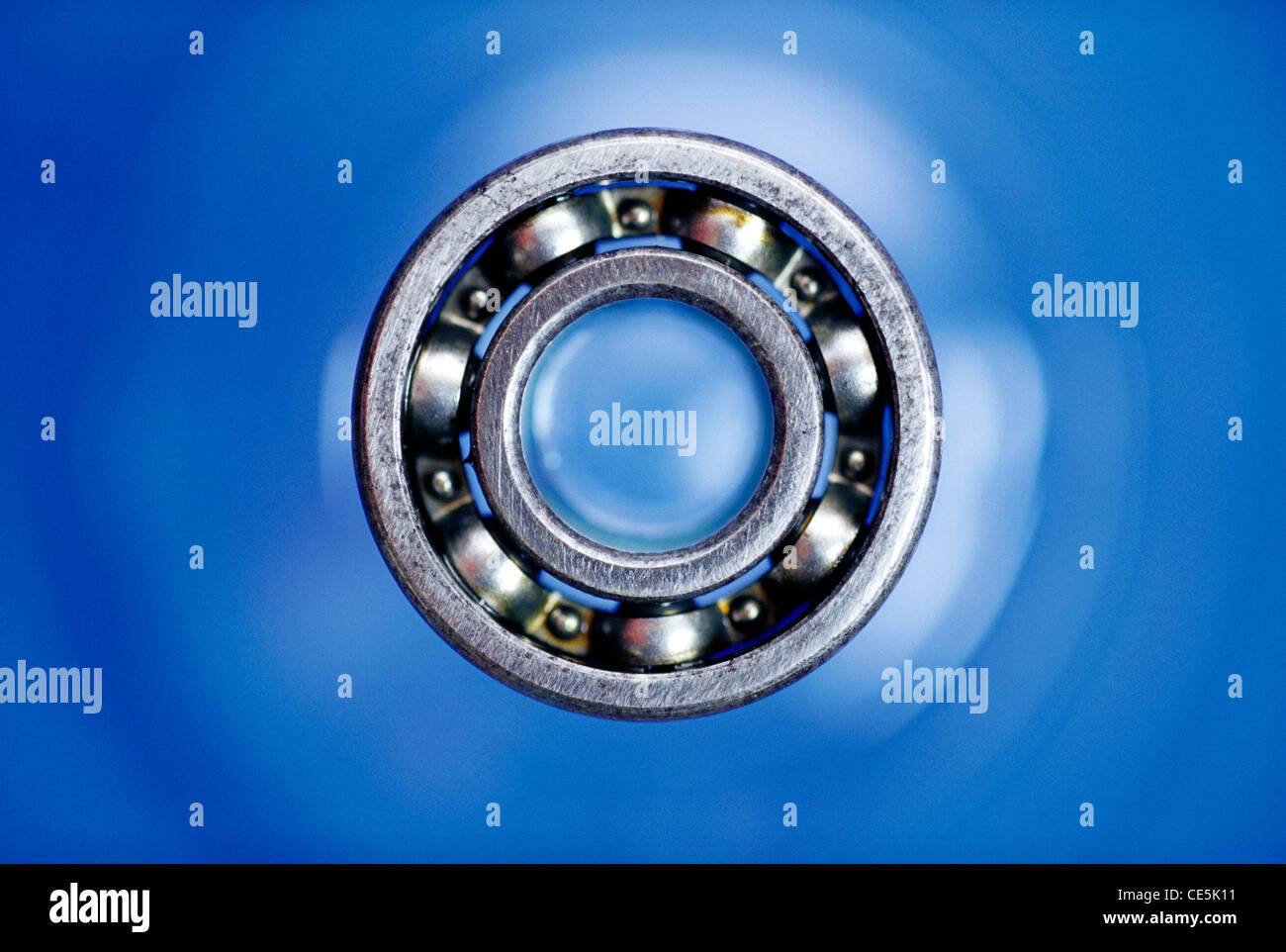 one ball bearing on blue background Stock Photo - Alamy