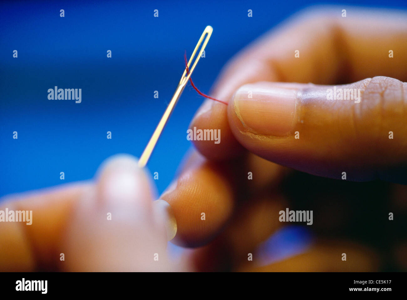 threading a needle Stock Photo - Alamy