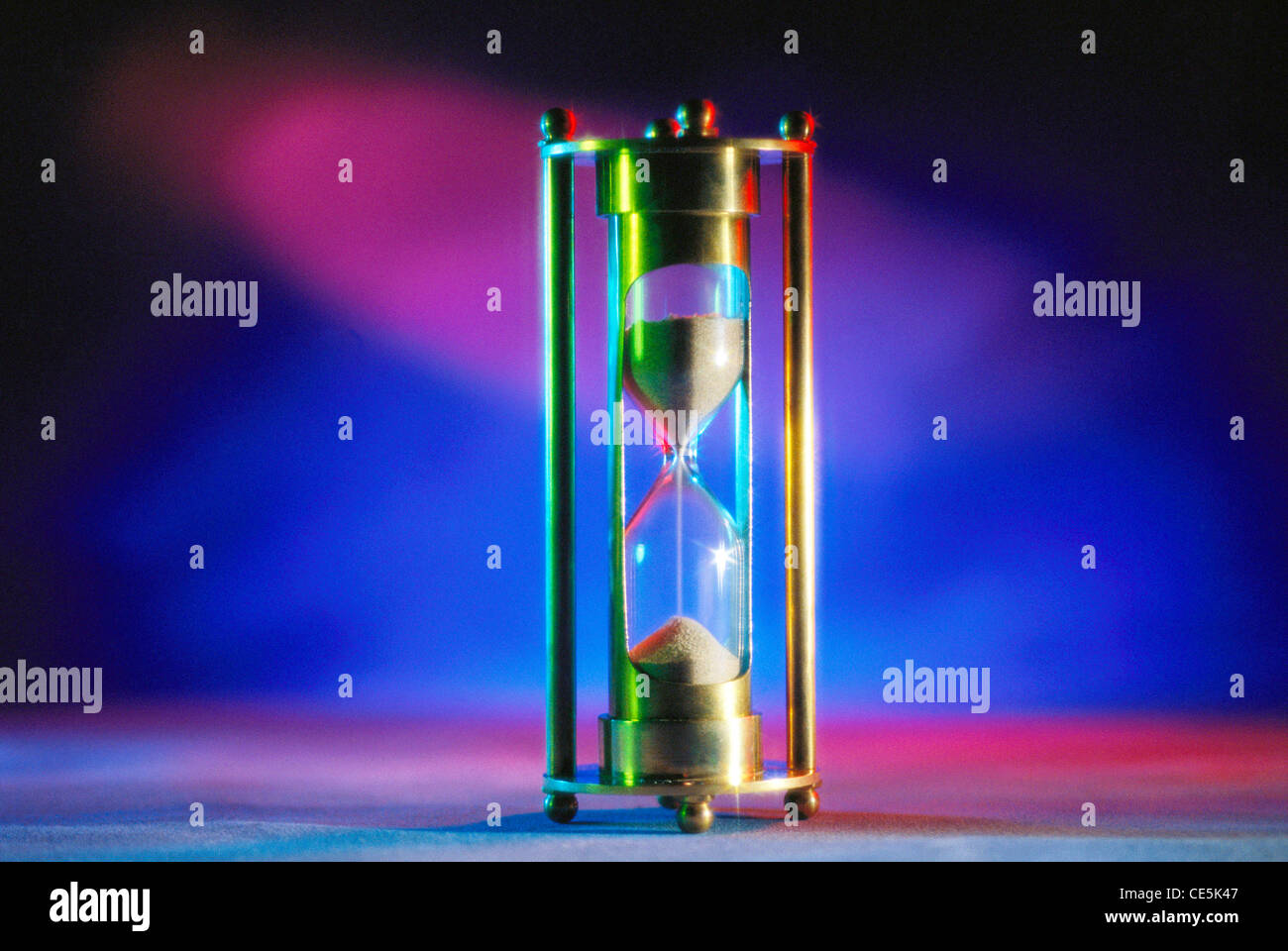 Concept time sand clock on colourful background Stock Photo - Alamy