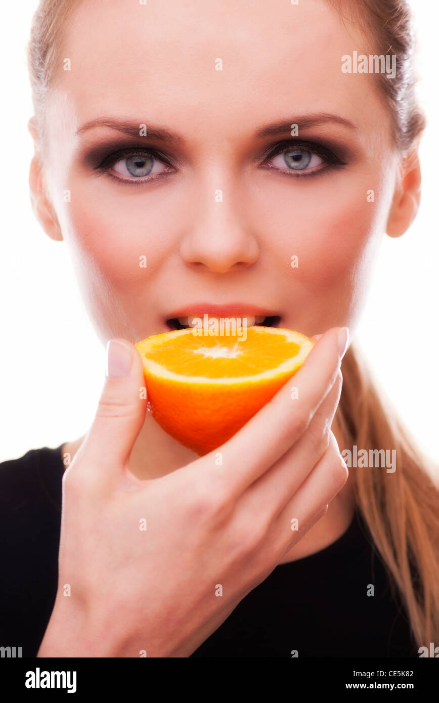 woman biting into half an orange Stock Photo - Alamy