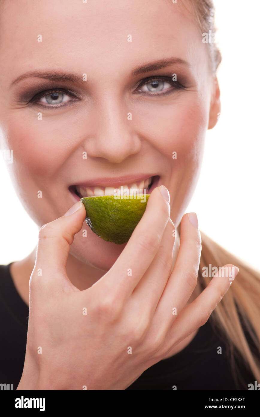 woman biting into half a lime Stock Photo - Alamy