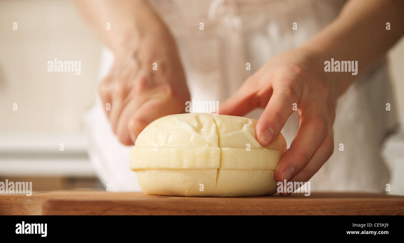 Female hand cutting cheese on hi-res stock photography and images - Alamy
