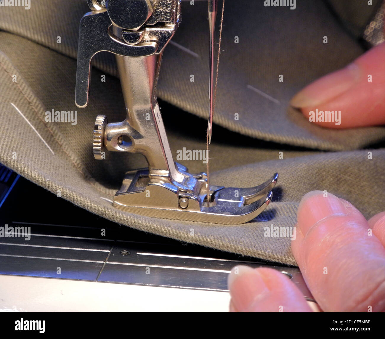 Sewing machine needle and foot (photographer's own hands Stock Photo ...