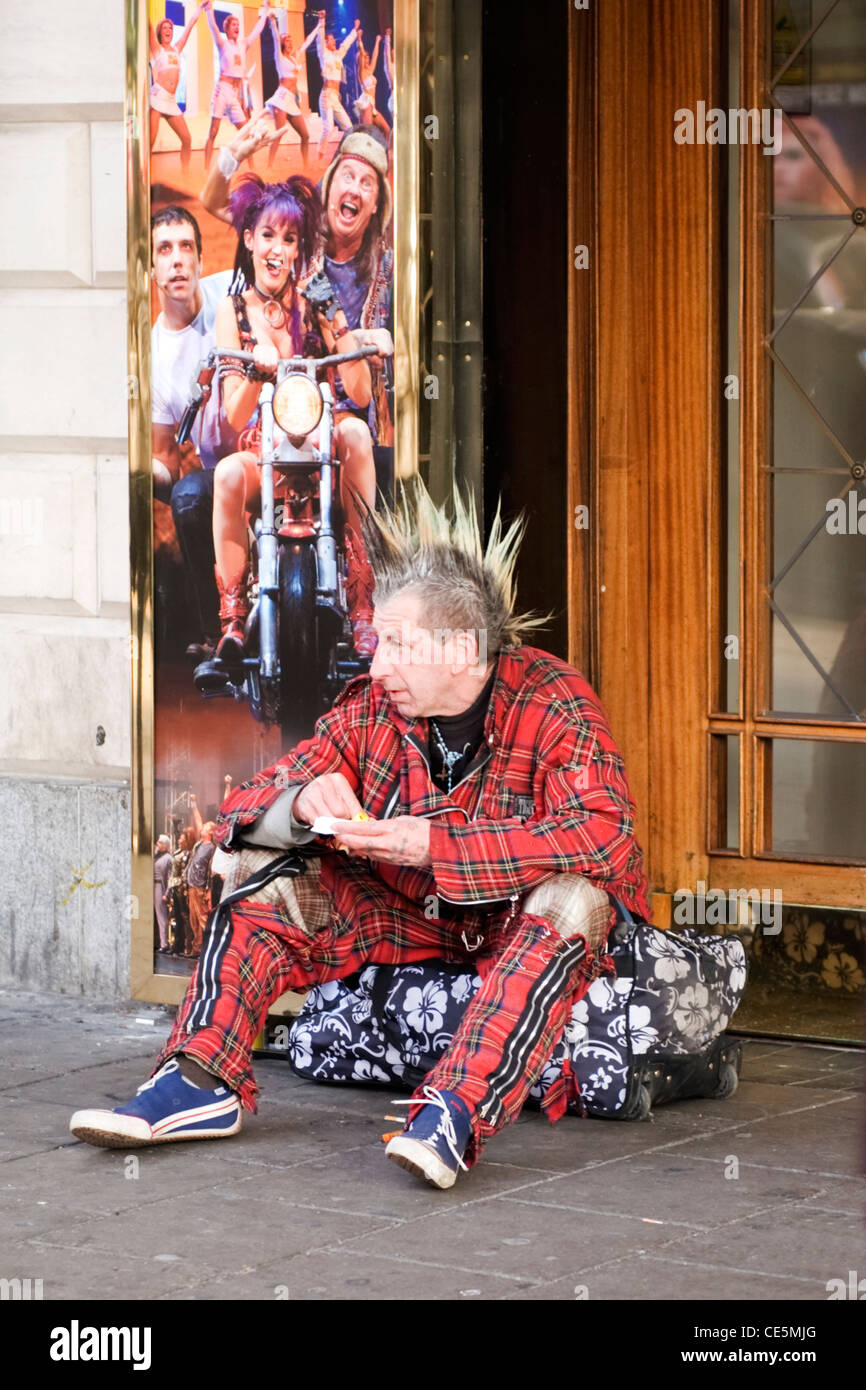 Tottenham Court Road West End London old punk rocker spiked hair worn ...