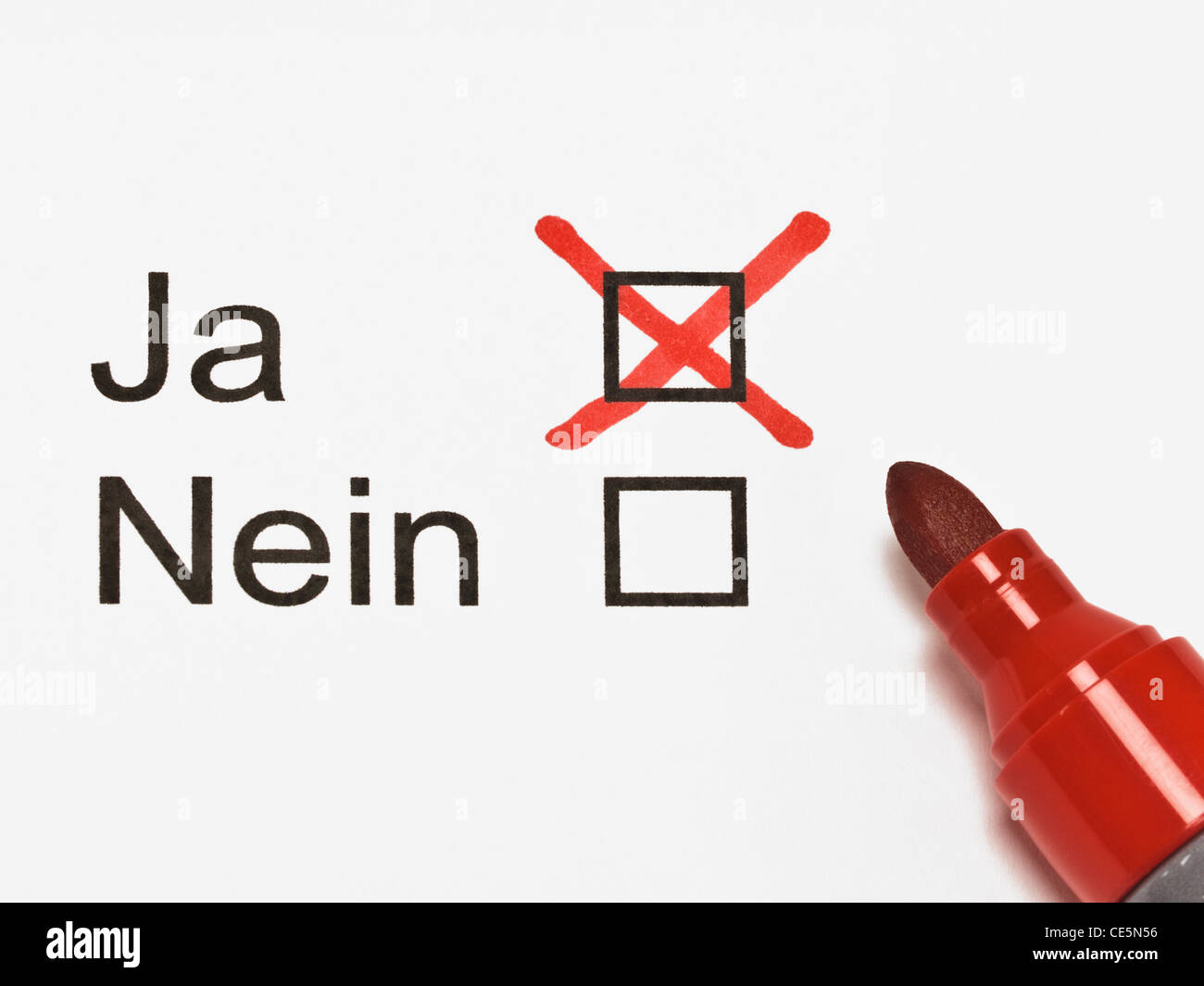 "Yes" in German is marked with a cross on a piece of paper. Beside is a ...