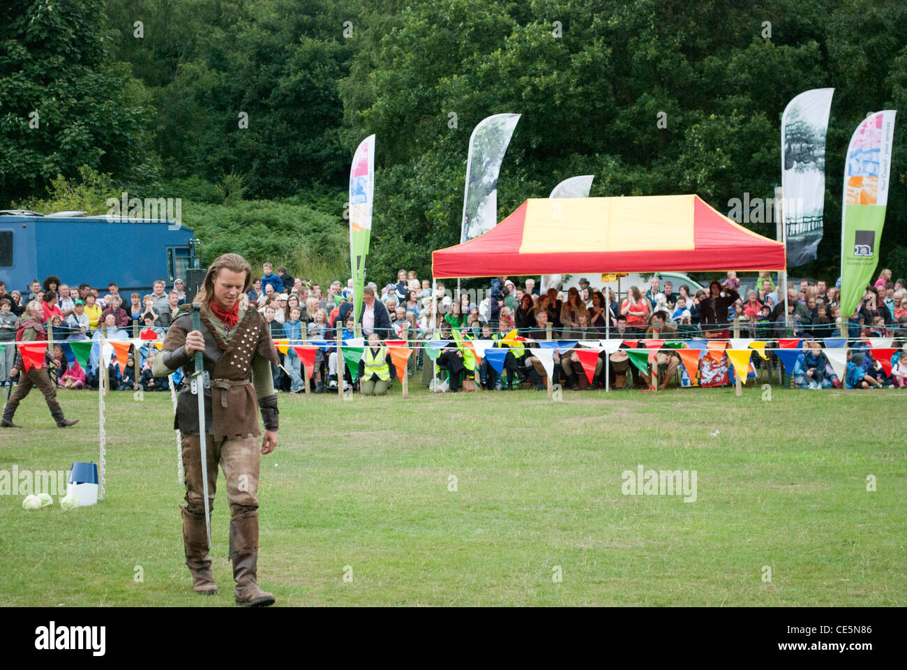 Man in medieval costume carrying sword at jousting tournament with ...