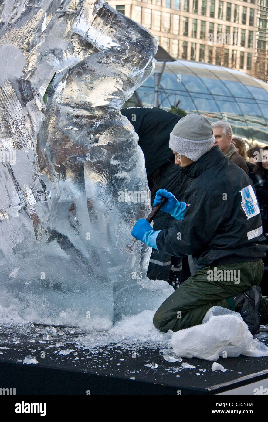 Man sculpting with chisel Ice Sculpting Festival Canary Wharf London ...