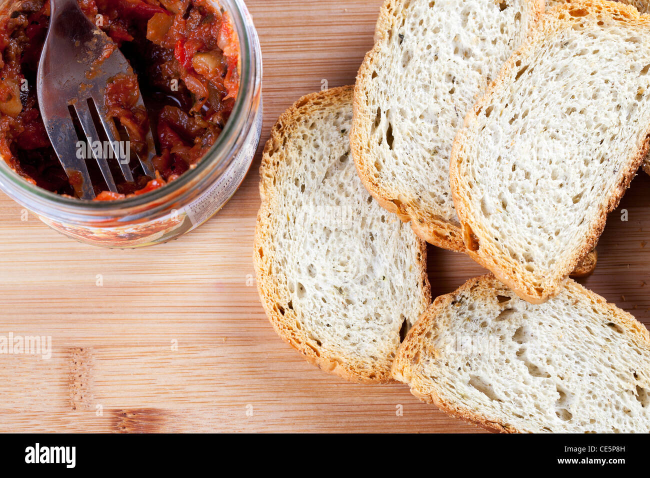 Toast and jar of bruschetta topping Stock Photo - Alamy