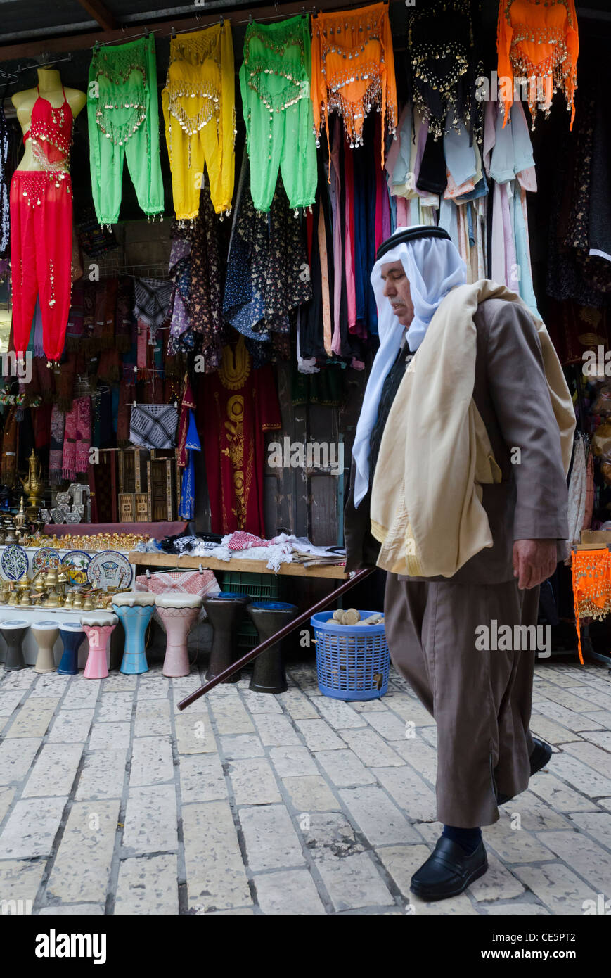 Palestinian man in traditional clothes walking pass belly dancing ...