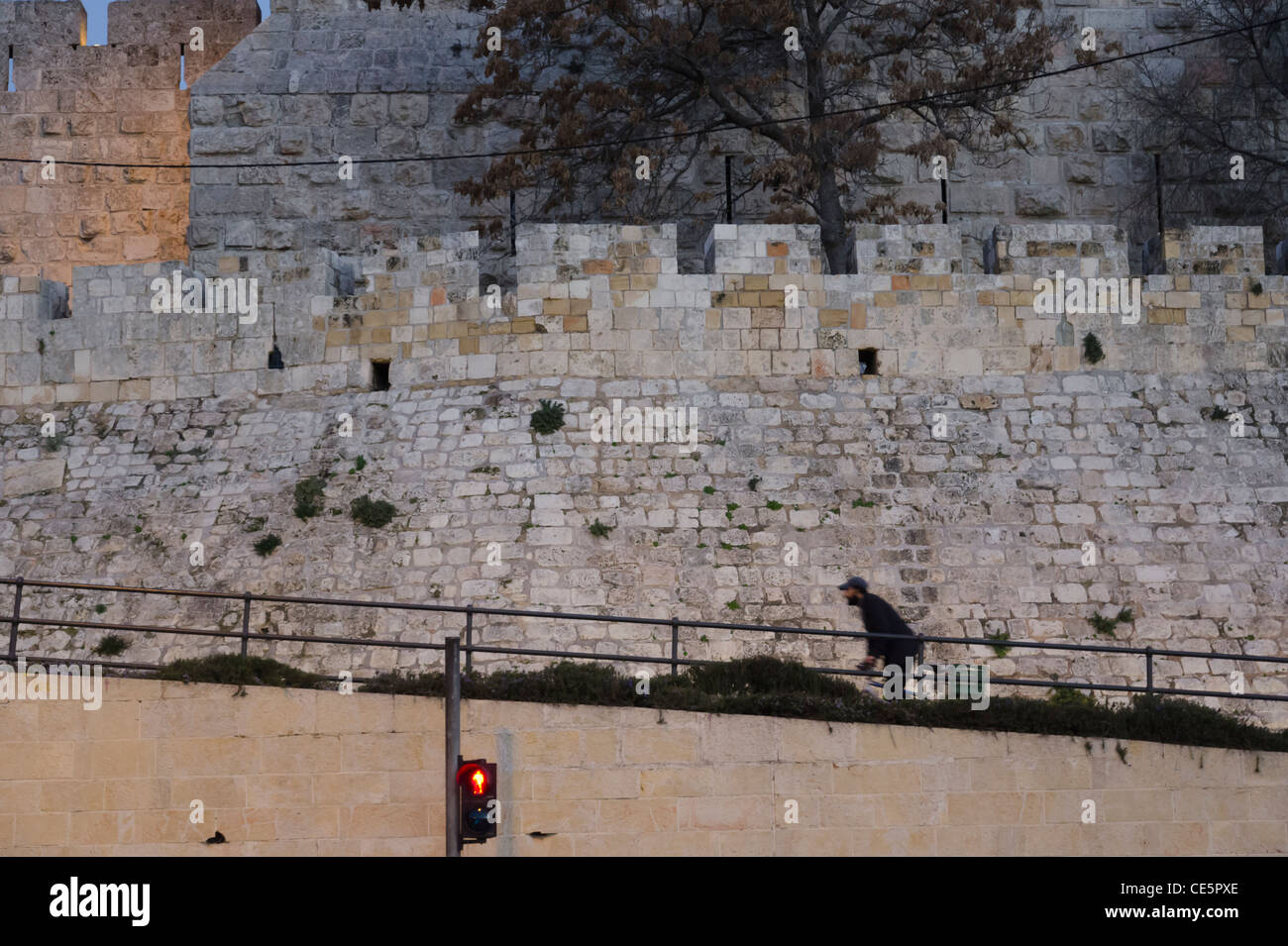 cyclist riding the ramp leading to Jaffa Gate with Tower of David in ...