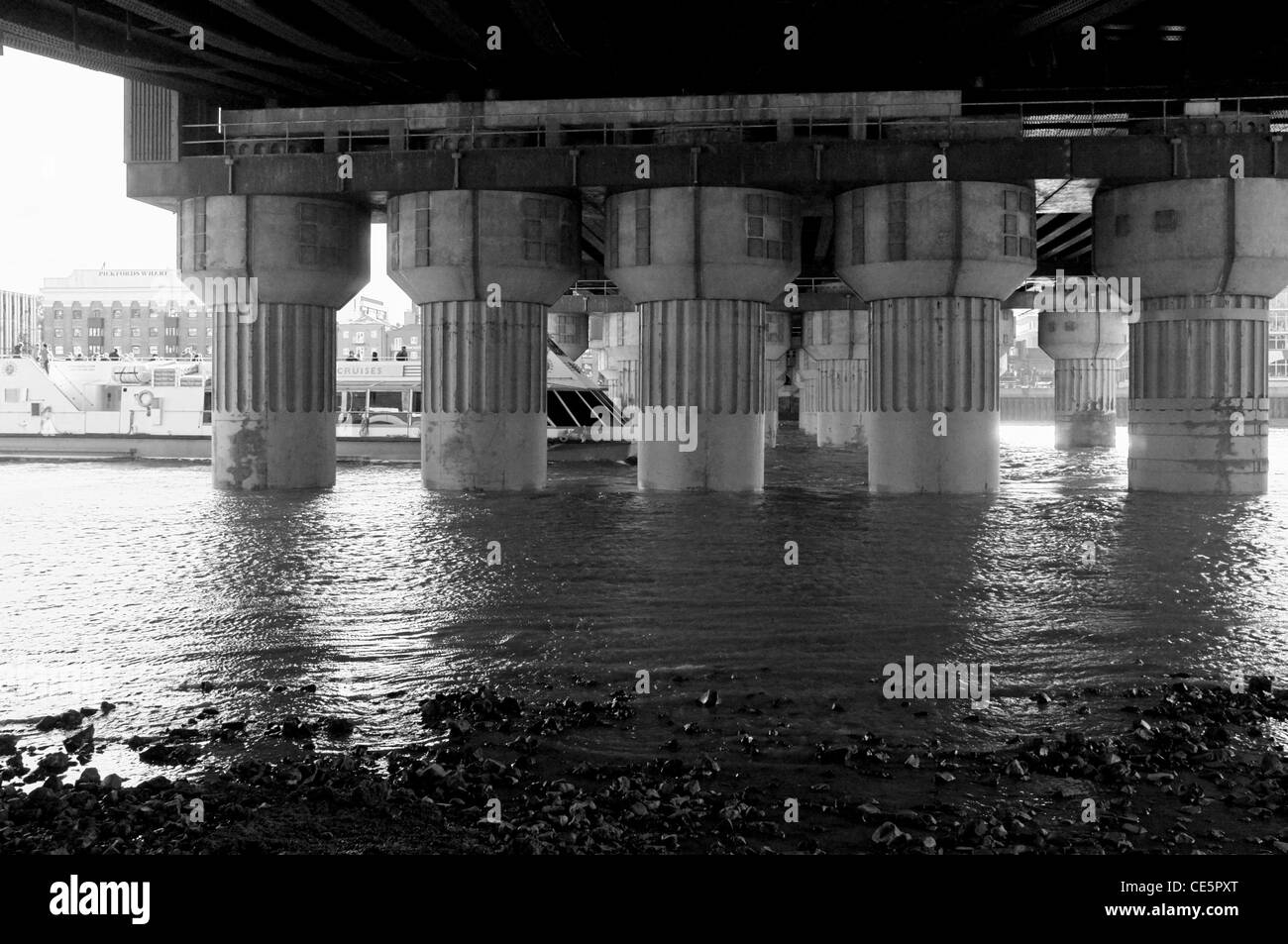View of bridge stanchions in the River Thames, black and white Stock ...