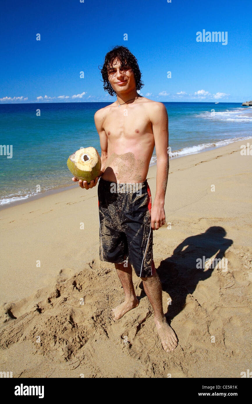 Man with coconut in hand on a beach Stock Photo - Alamy
