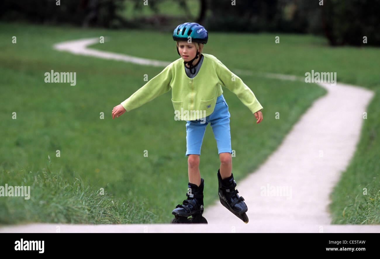 Young girl rollerblading in park Stock Photo - Alamy