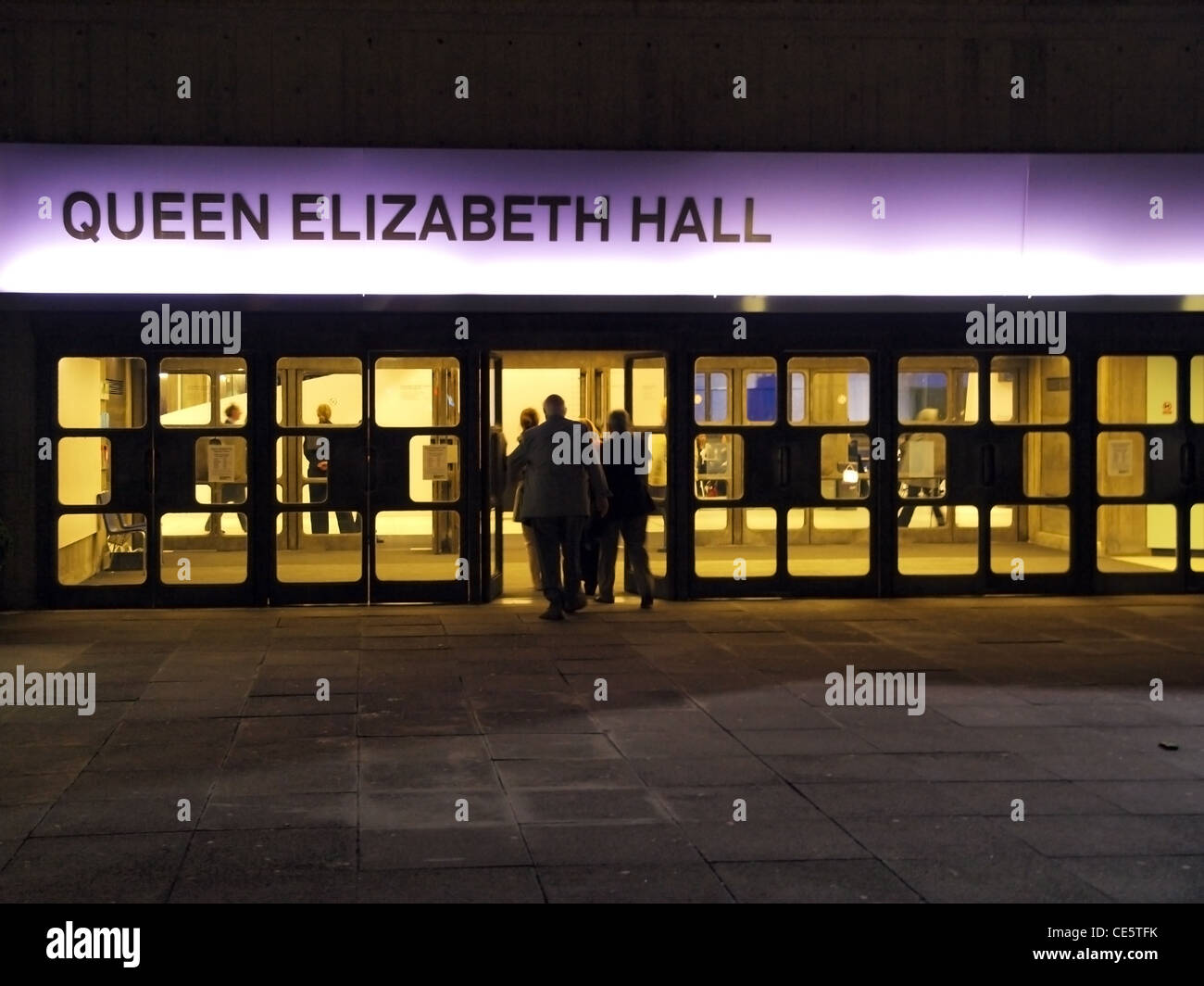 Some people enter the illuminated entrance to London's Queen Elizabeth ...