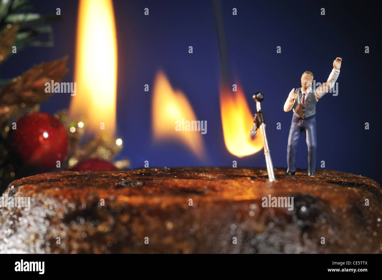 A model photographer behind fire on a christmas pudding Stock Photo - Alamy
