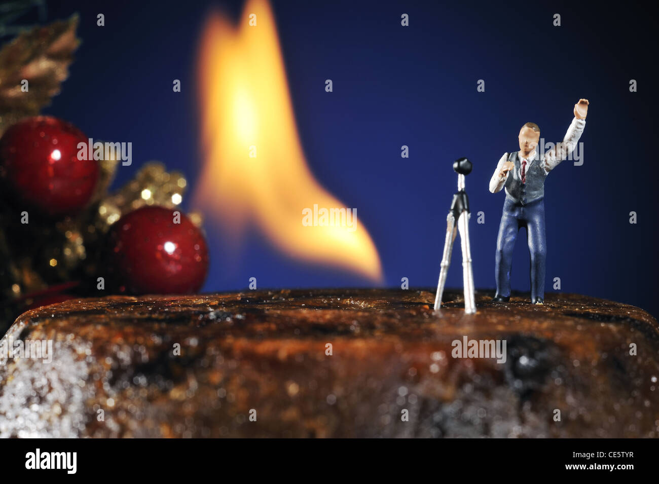 A model photographer behind fire on a Christmas pudding Stock Photo - Alamy