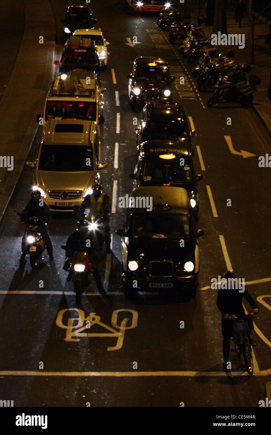 Looking down on a queue of traffic waiting at traffic lights in London ...