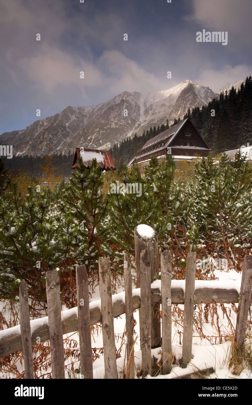 Snow at the moutain cottage at Popradske Pleso lake below the peaks of ...