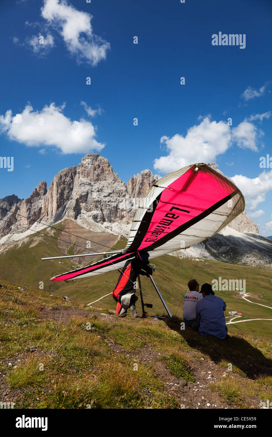 Hang glider launching from hillside on Col Rodella, in Dolomite Alps ...