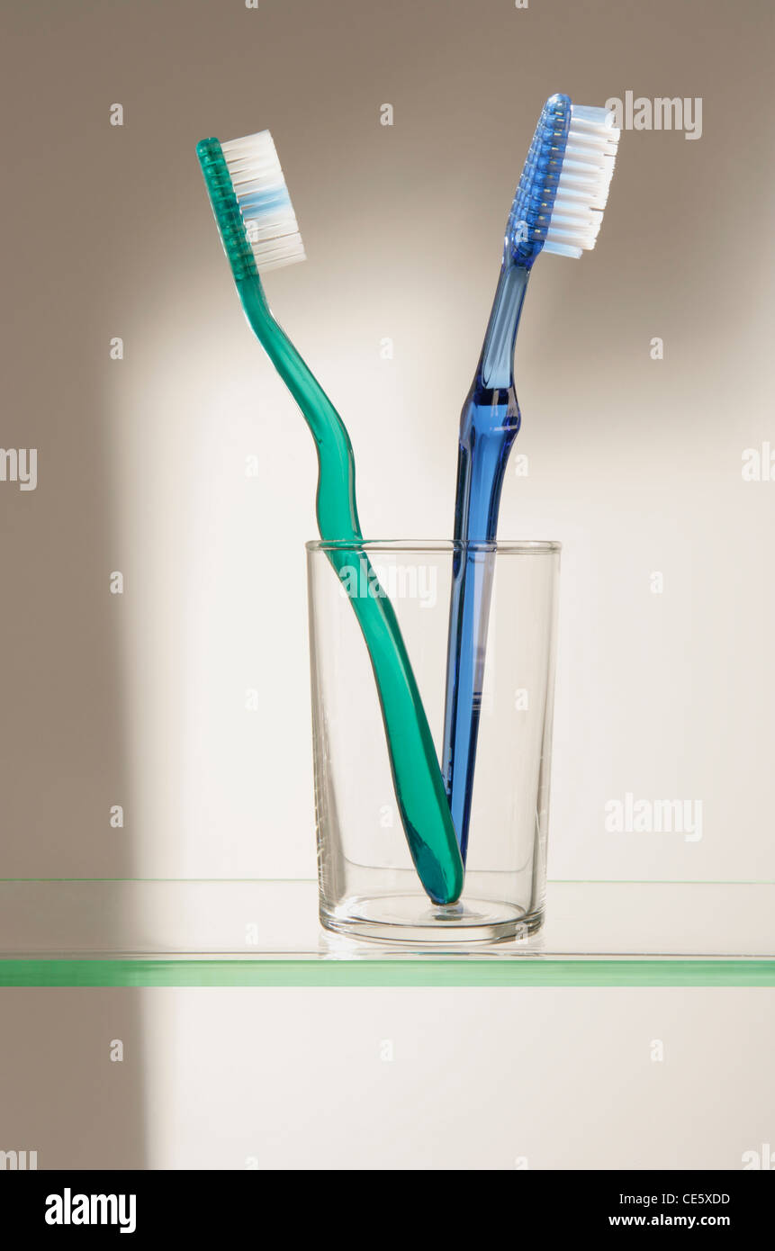 Two toothbrushes in glass Stock Photo - Alamy