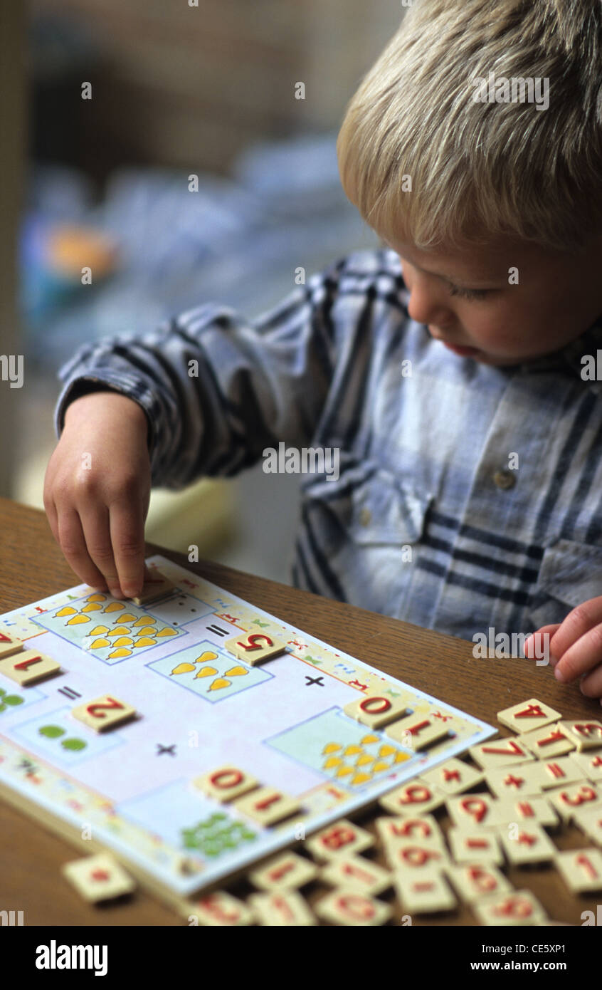 Boy doing arithmetic on board game Stock Photo - Alamy