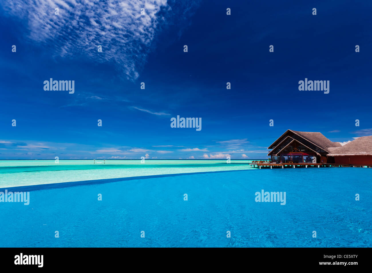 Infinity pool over tropical lagoon with almost clear blue sky Stock ...