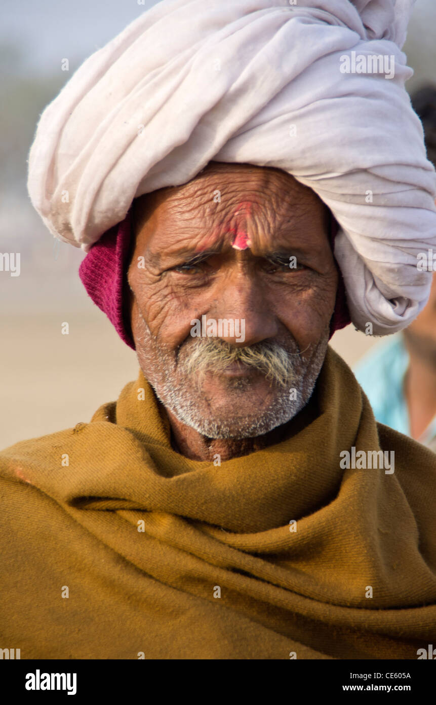 a hindu pilgrim at Sangam with a white turban, mustache, and tilak ...