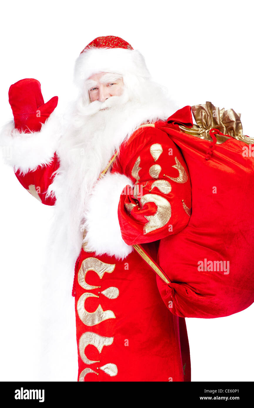 Santa Claus standing up on white background with his bag full of gifts ...