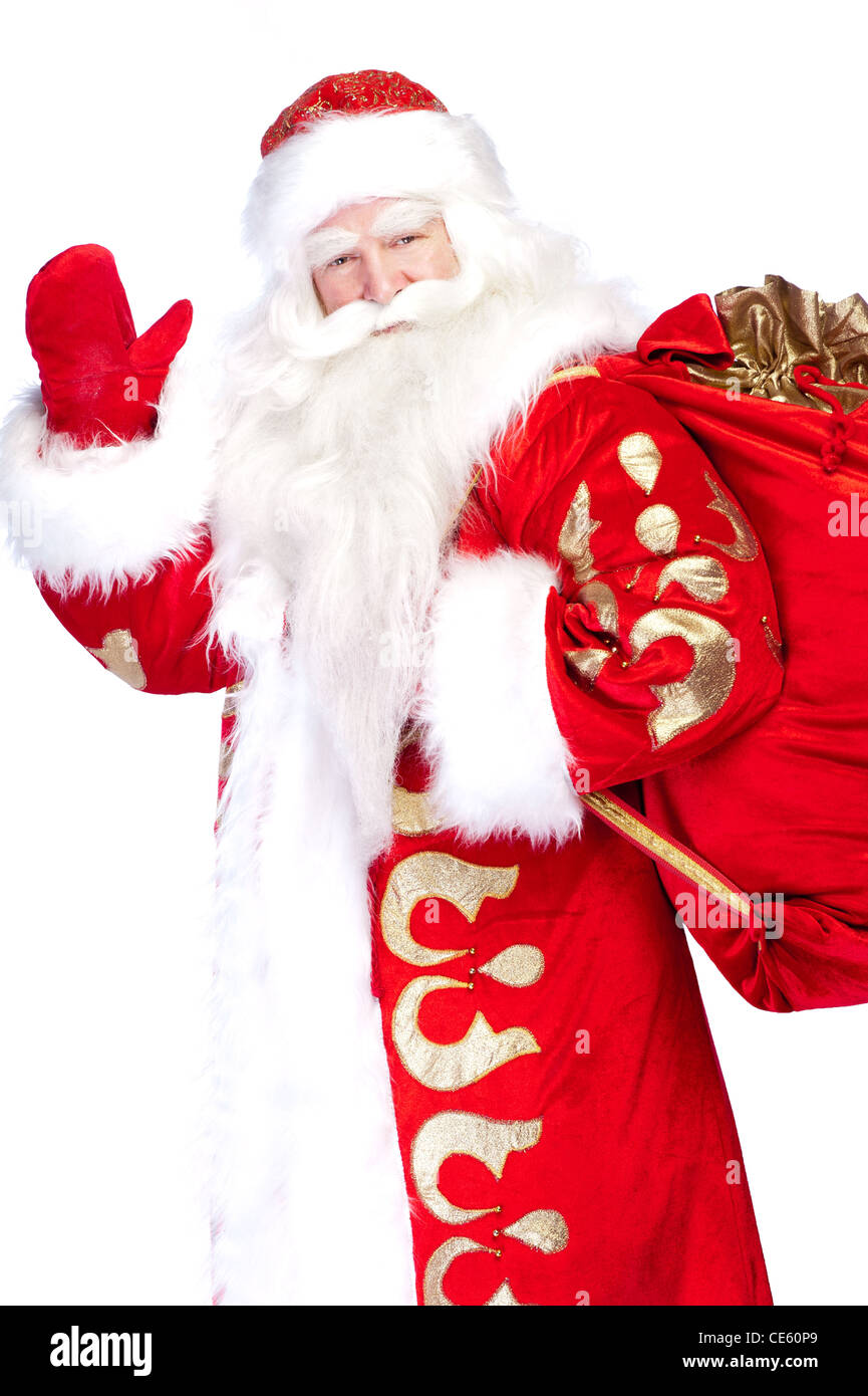 Santa Claus standing up on white background with his bag full of gifts ...