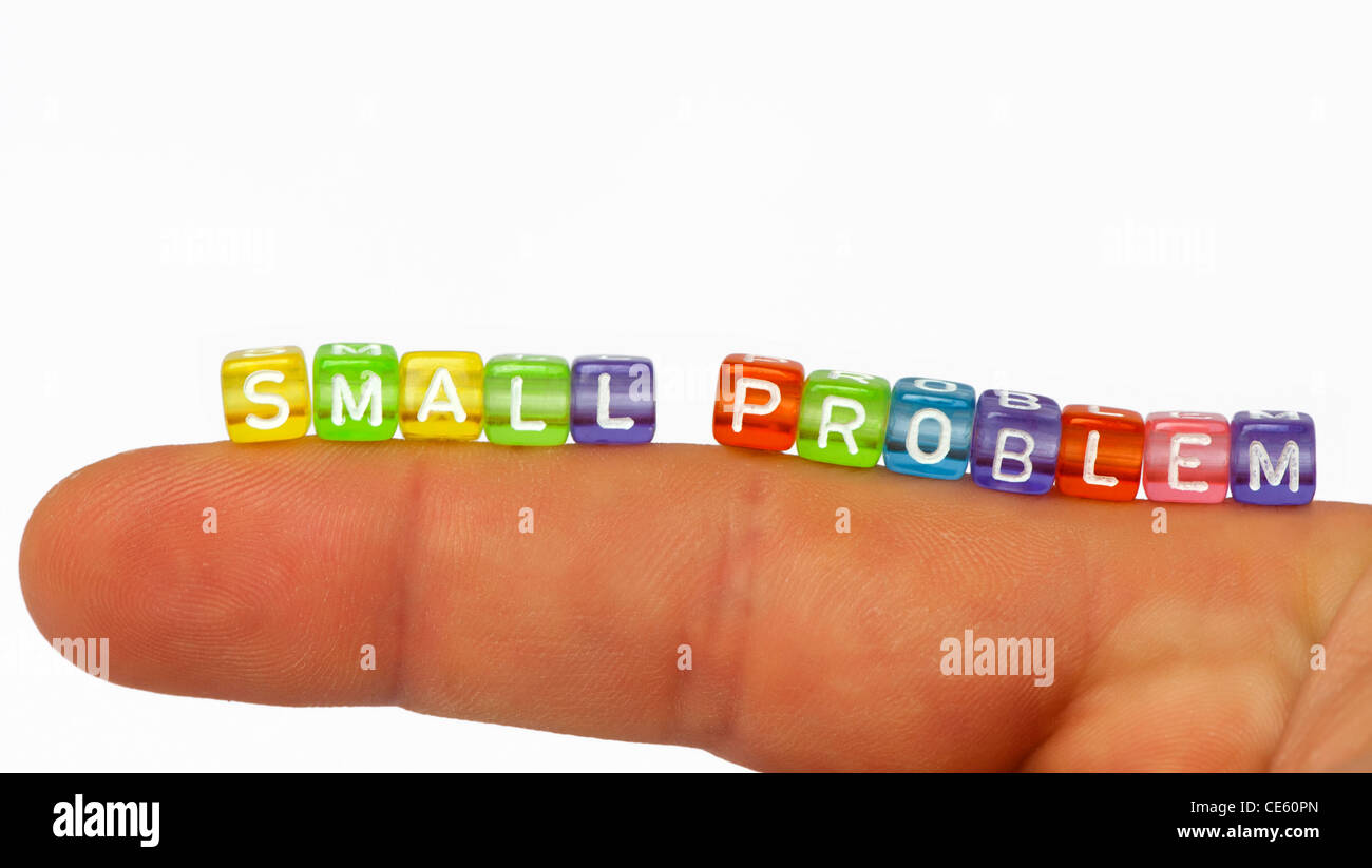 Text Small Problem. Very small colorful cubes on finger Stock Photo - Alamy