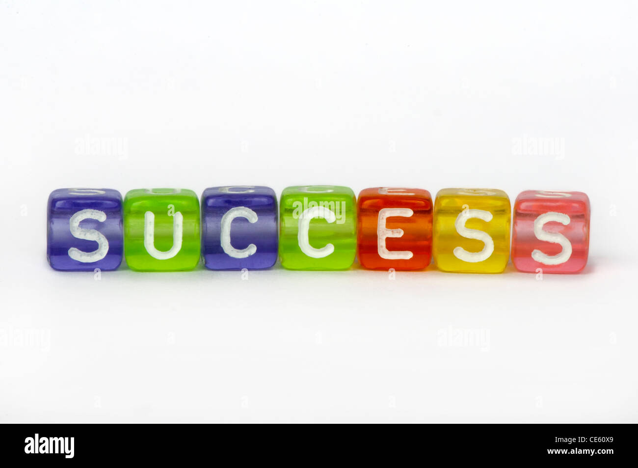 Text success on colorful wooden cubes over white Stock Photo - Alamy