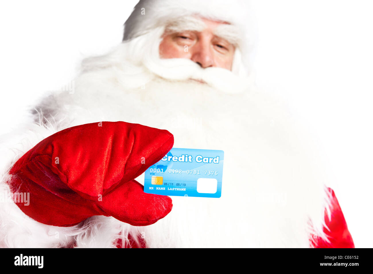 Traditional Santa Claus holding and sowing credit card while giving a ...