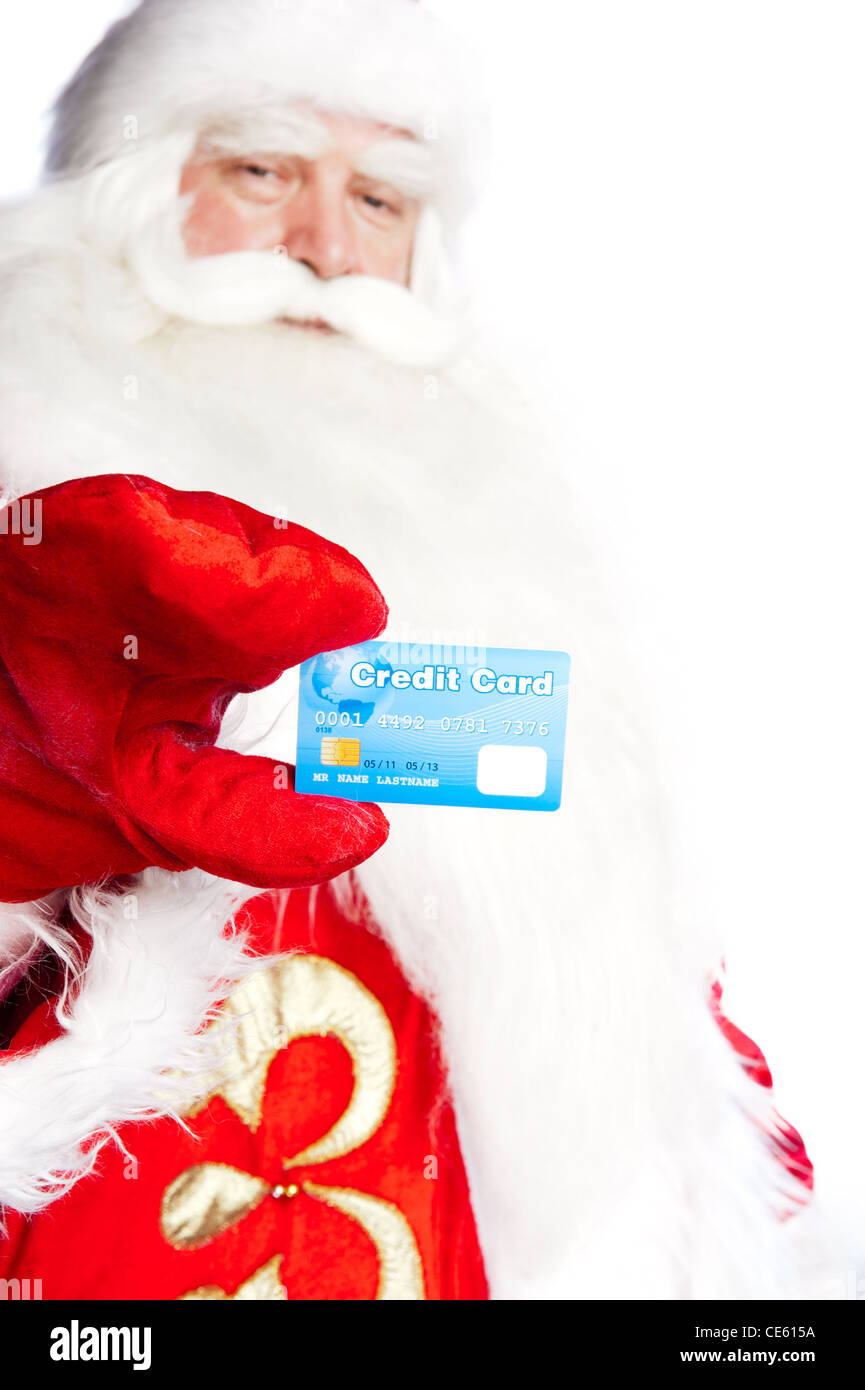 Traditional Santa Claus holding and sowing credit card while giving a ...