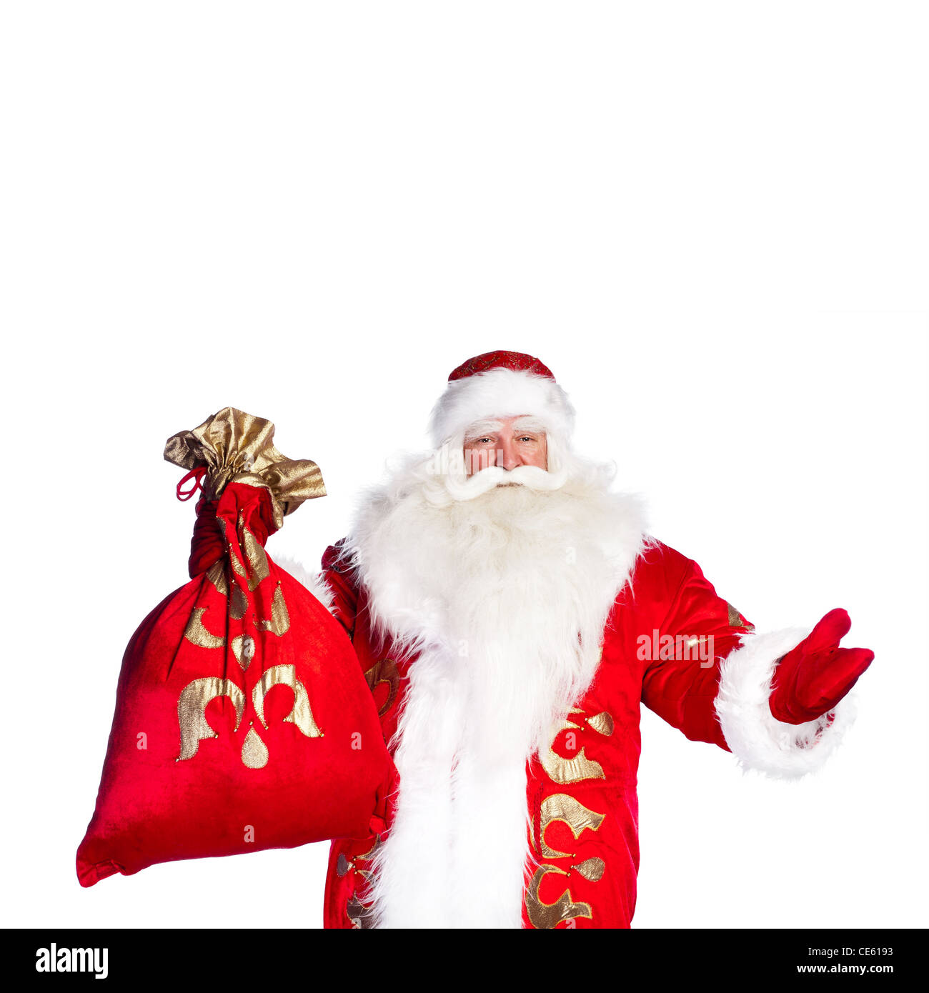 Santa Claus standing up on white background with his bag full of gifts ...