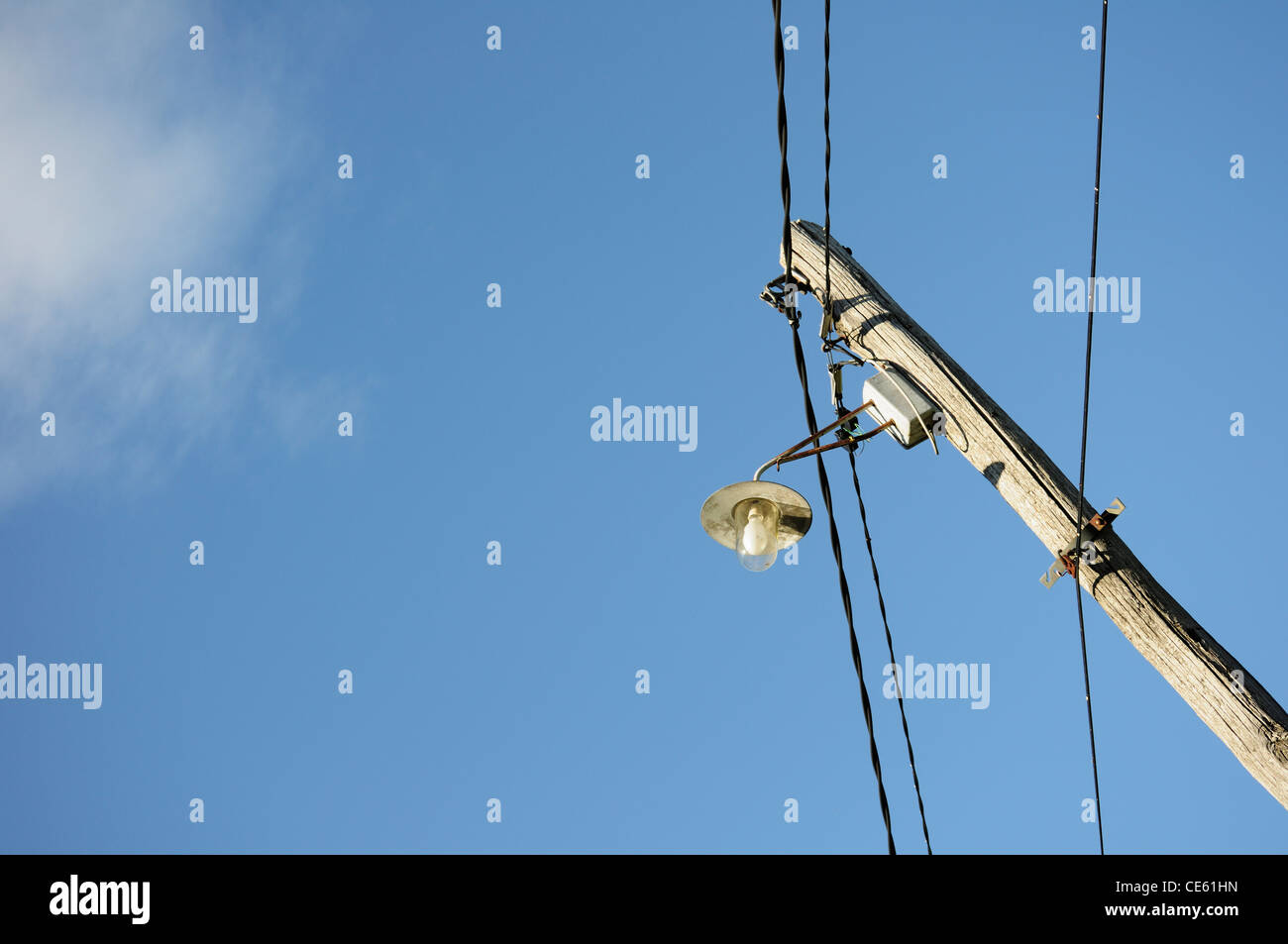 Power pylon with and street lamp against blue sky Stock Photo - Alamy