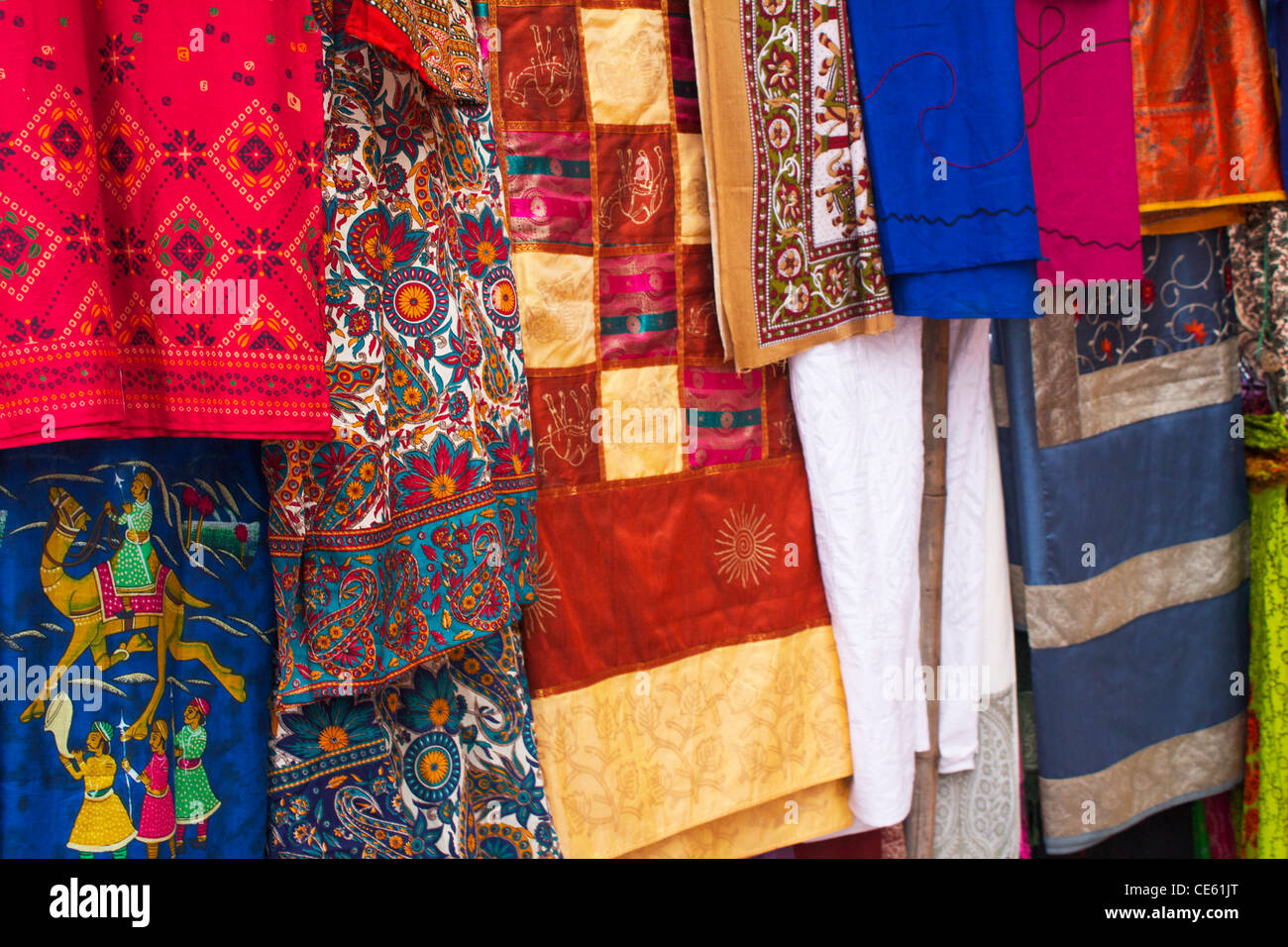 A selection of bright hanging fabrics at a street market in India Stock ...