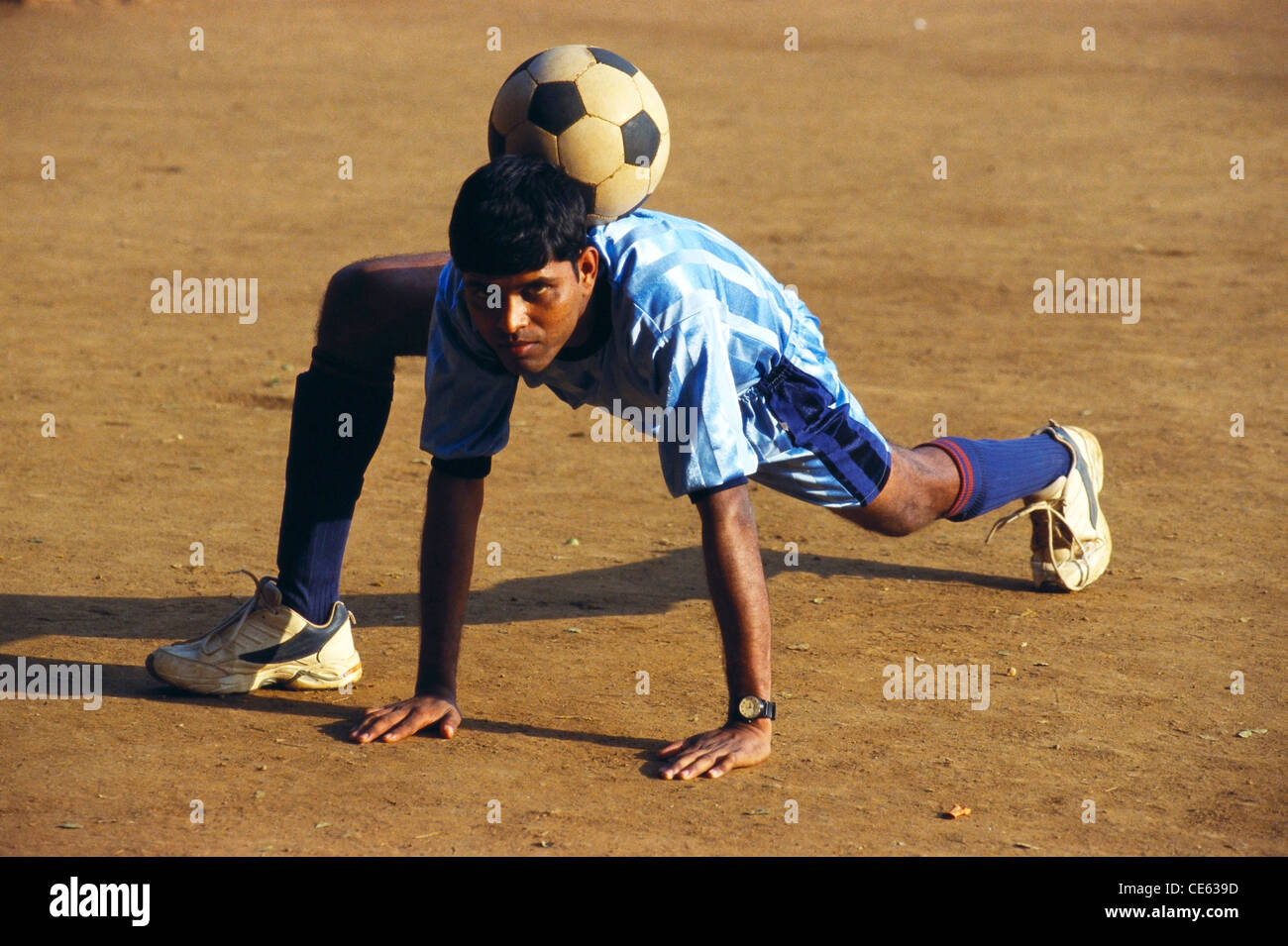 Boy balancing football on back of head and nape of neck MR#672A Stock ...