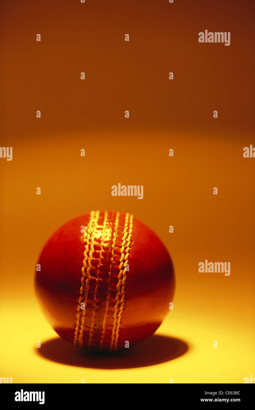 Cricket ball on yellow orange background Stock Photo - Alamy