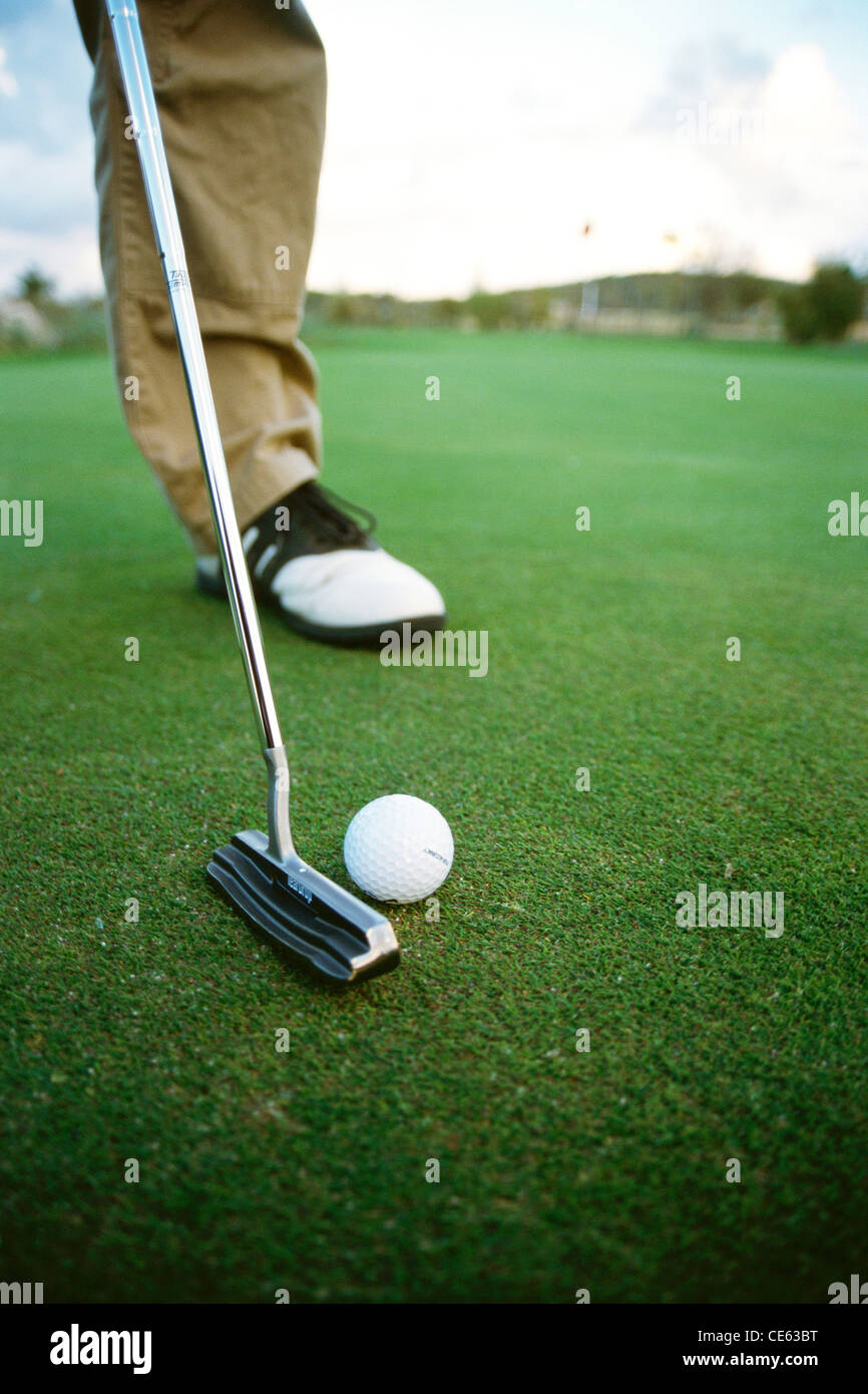 Indian golfer hitting golf ball with putter ; India ; asia ; MR#524 ...