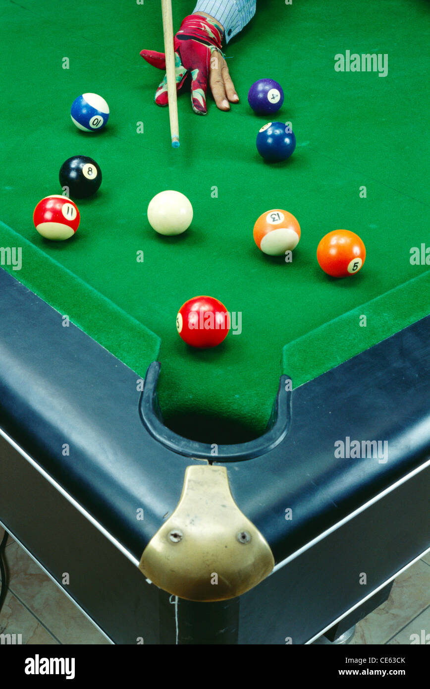 Billiards pool balls on pool table and man playing with cue ball Stock ...