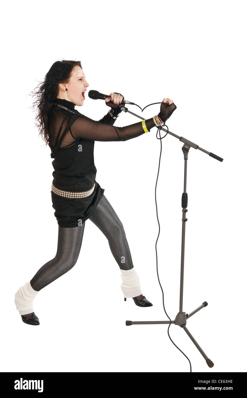 Passionate singer with microphone performing over white background ...