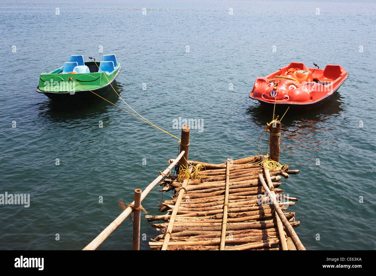 two plastic boats moored quay wooden jetty backwater Tarkarli Malvan ...