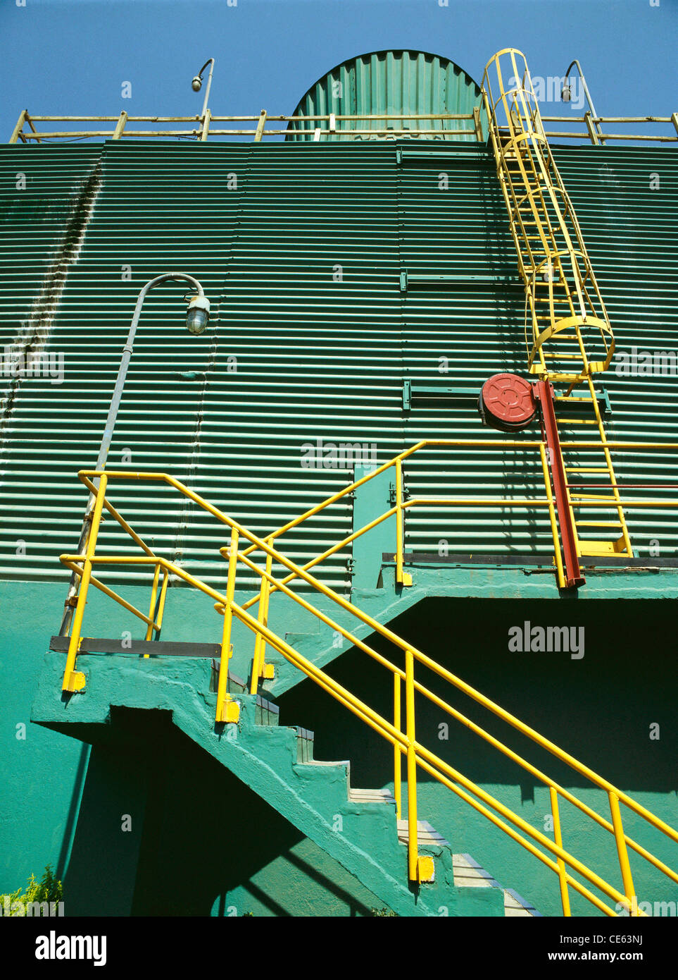 Fire Exit ; yellow painted metal staircase on green wall ; India ; asia ...