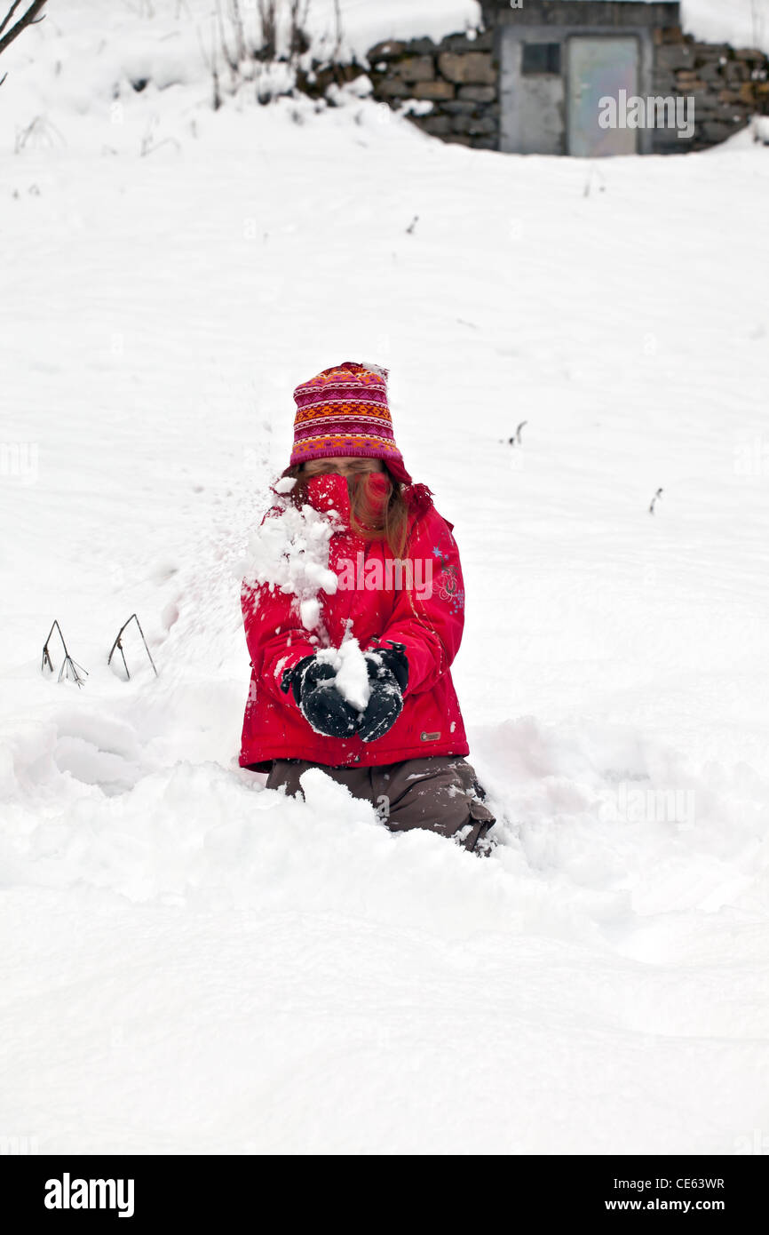 Girl gets snowball in a snowball fight at the head Stock Photo - Alamy