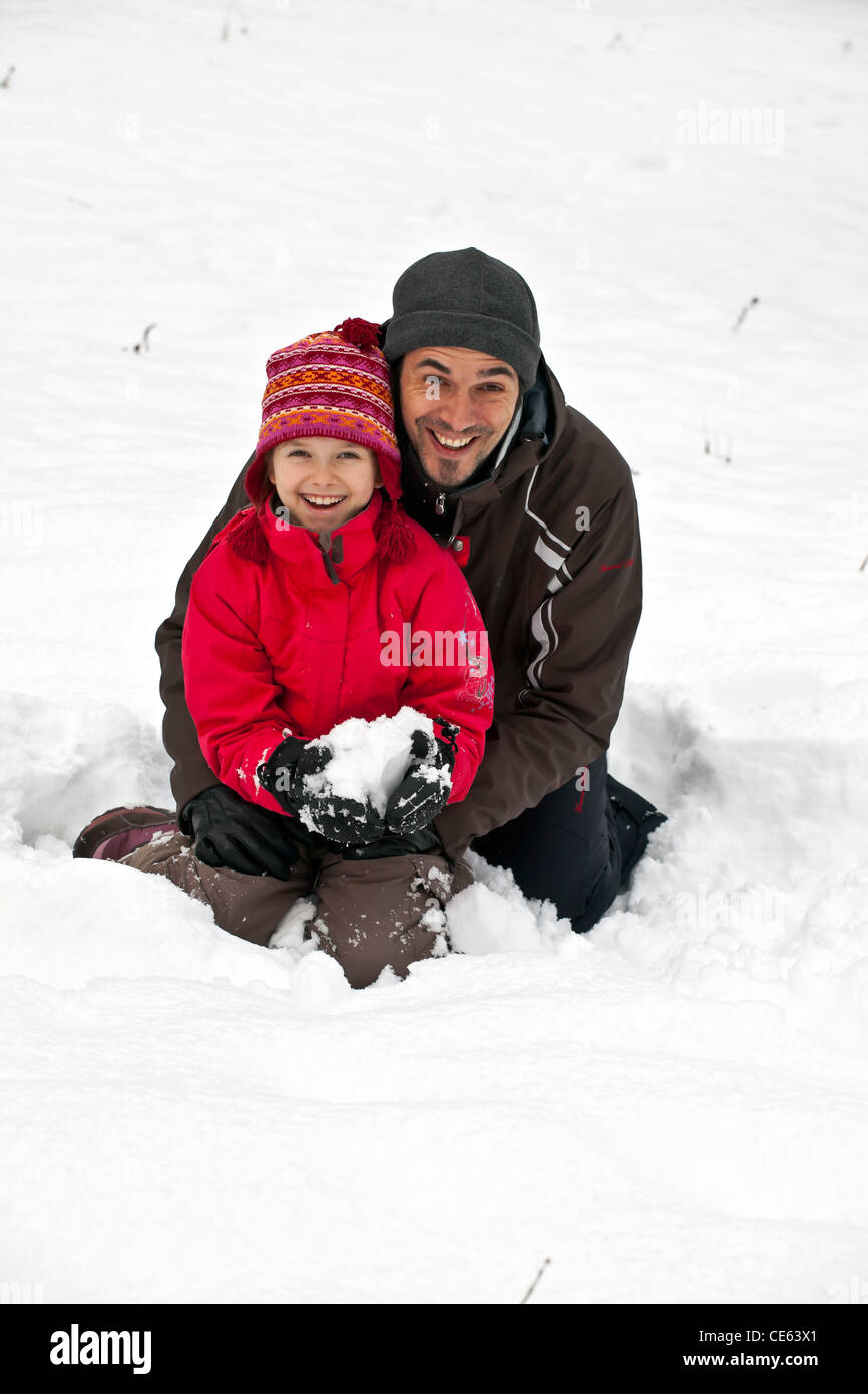 father and daughter are playing in the snow Stock Photo - Alamy