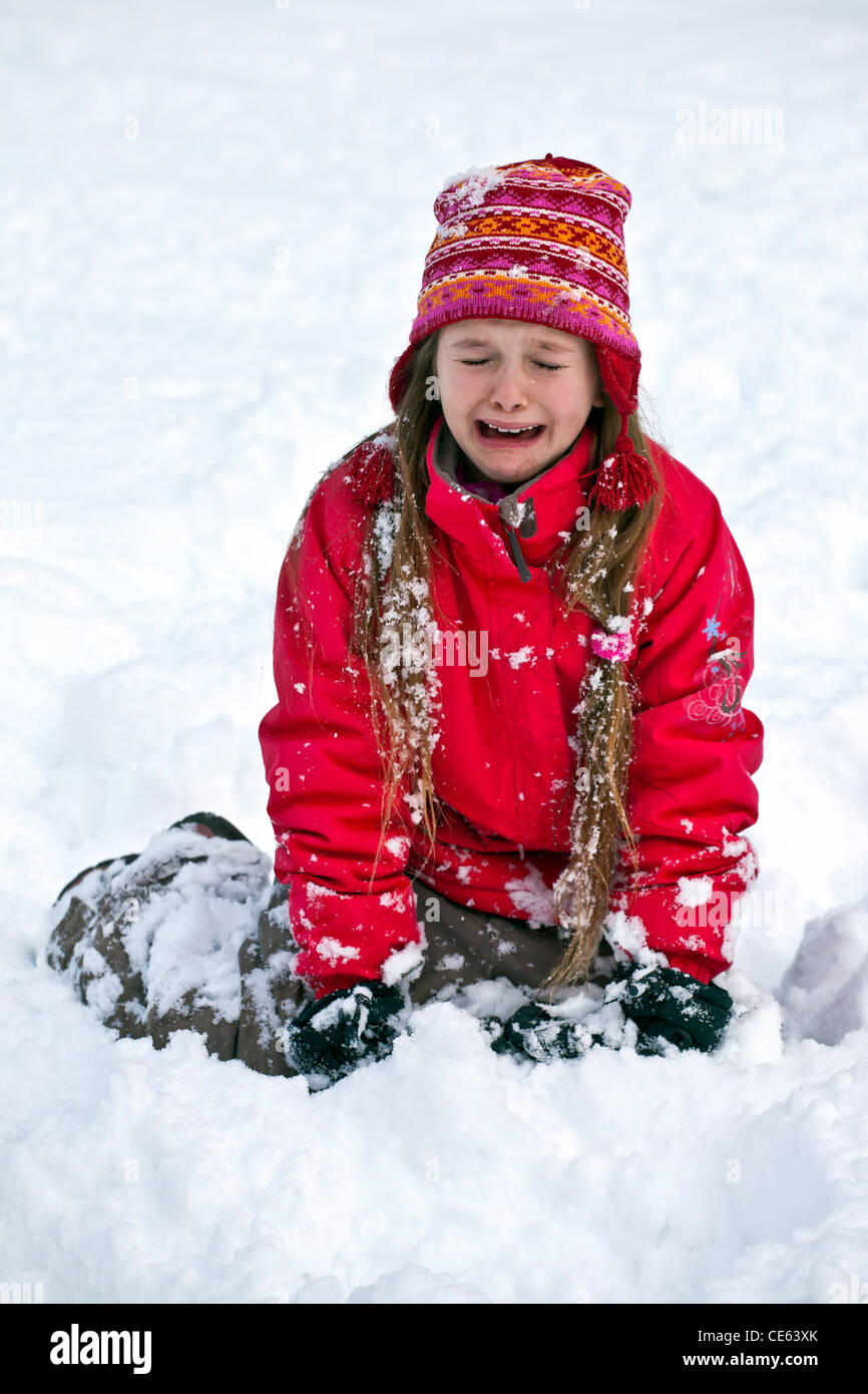 Girl sitting in the snow and cries Stock Photo - Alamy